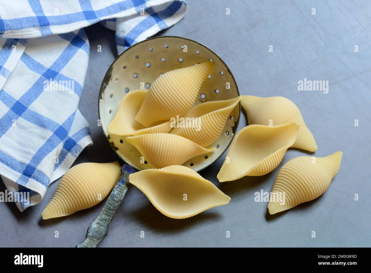 Conchiglione with sieve ladle, shell pasta, pasta Stock Photo - Alamy