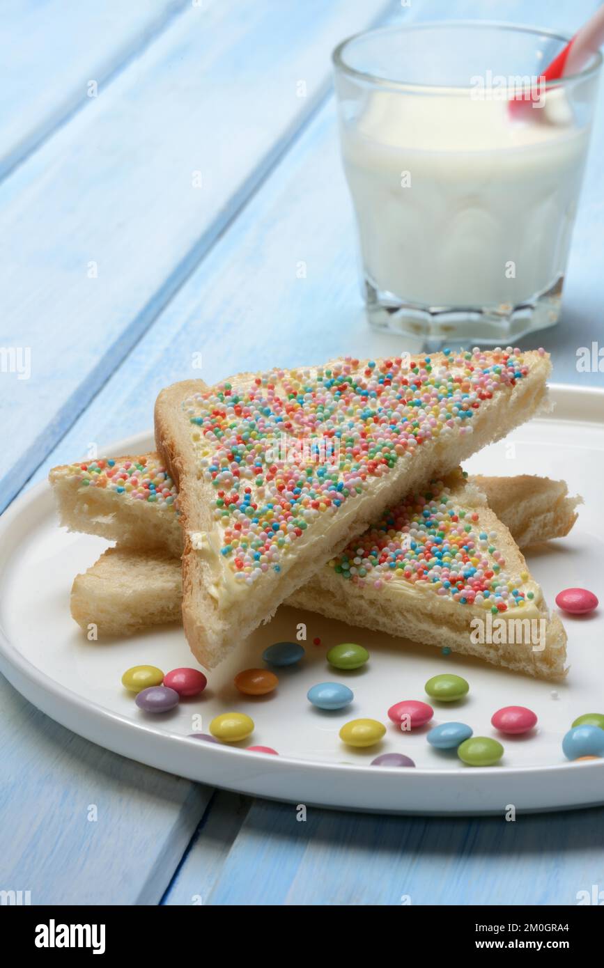Fairy bread, toast with sugar sprinkles and glass of milk Stock Photo ...