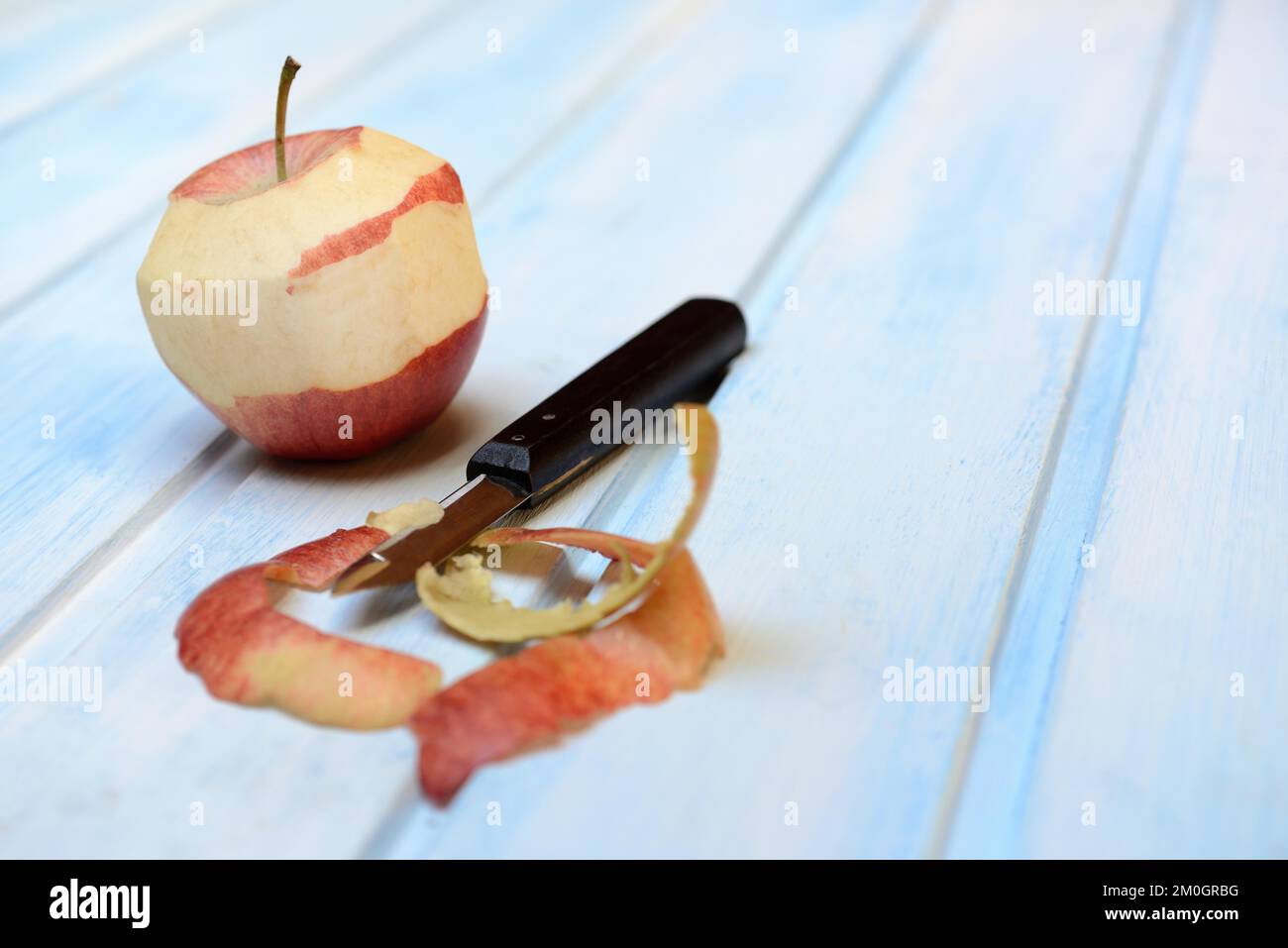 Peeled apple with peeling knife, apple peels Stock Photo - Alamy