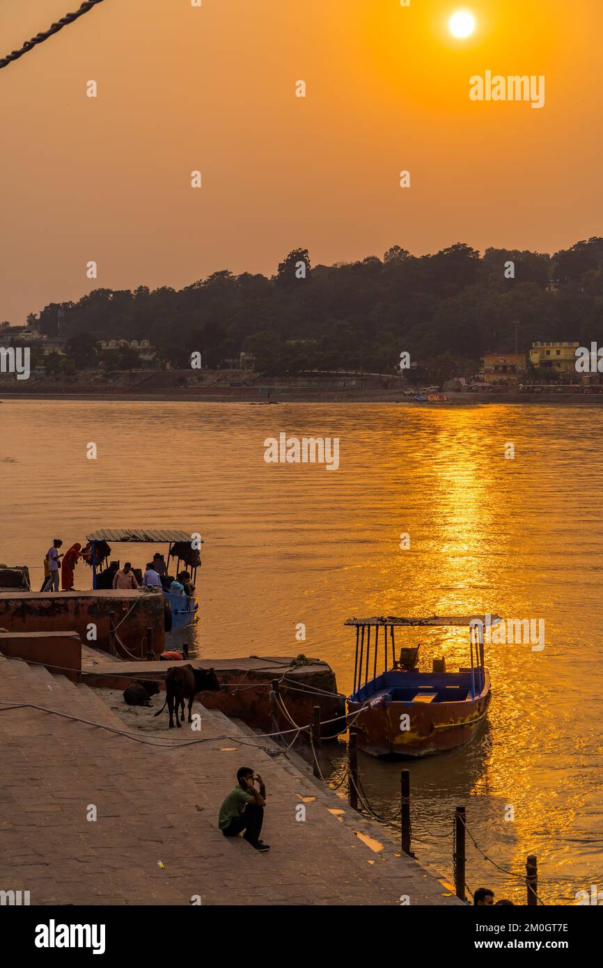 A vertical shot of old boats on the Ganges river during dramatic sunset ...