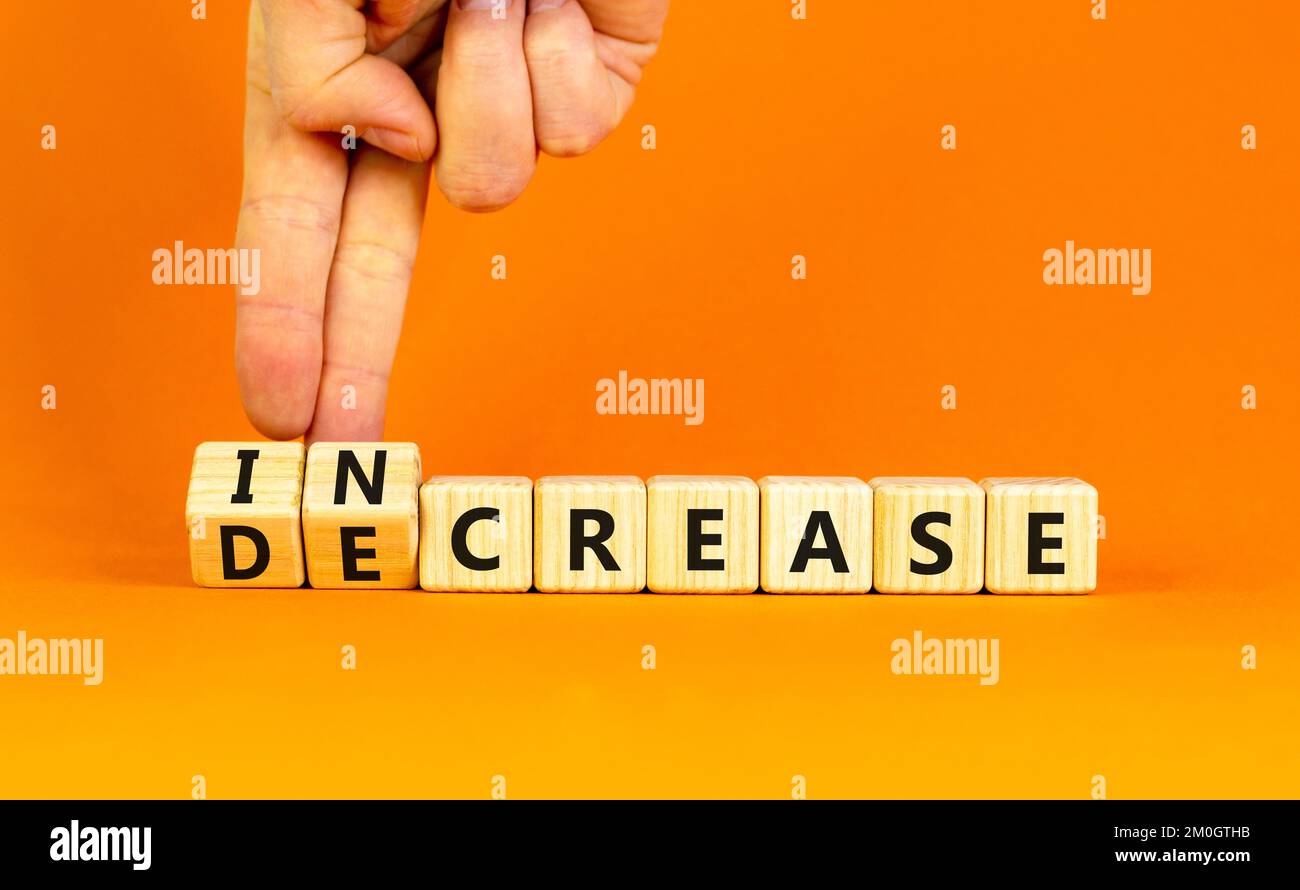 Increase or decrease symbol. Concept words Increase and Decrease on wooden cubes. Businessman ...