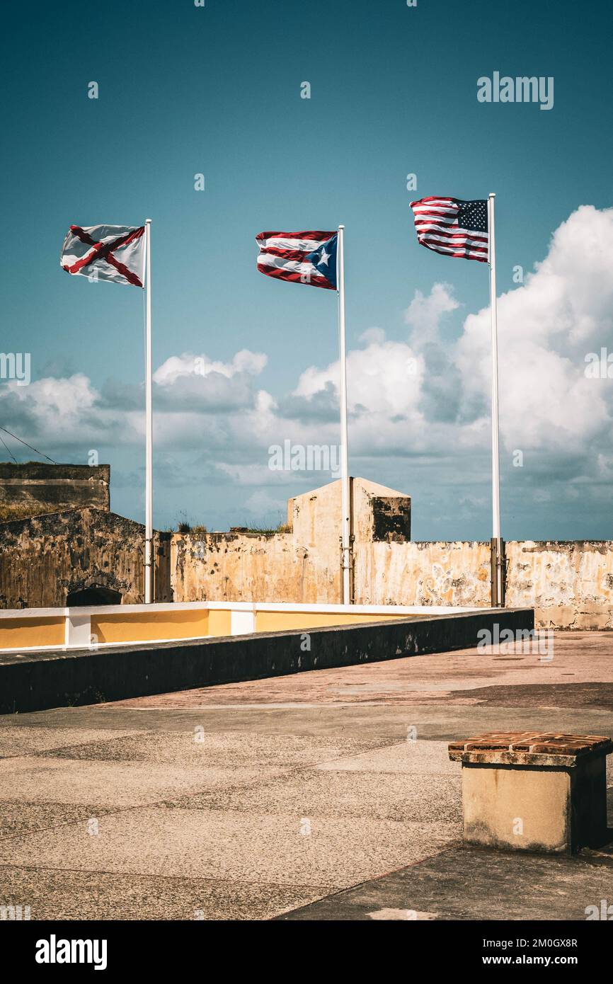 A vertical shot of Puerto Rico, American and Cross of Burgundy flags on ...