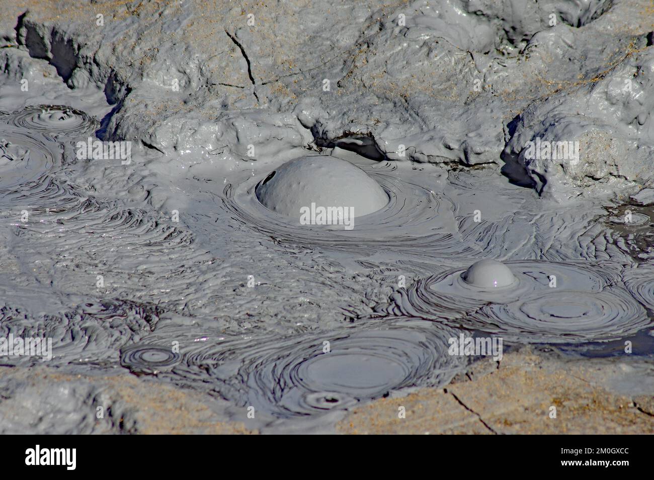 Smacking and bubbling mud springs, barren moon-like landscape ...