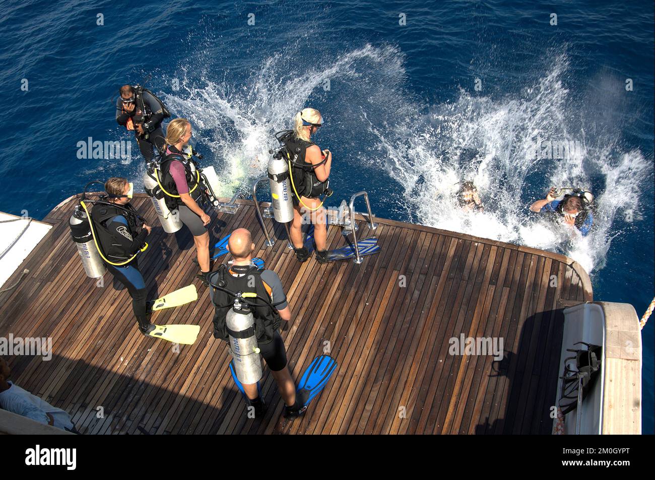 Divers Sport divers jump from dive deck of dive ship for dive cruise ...