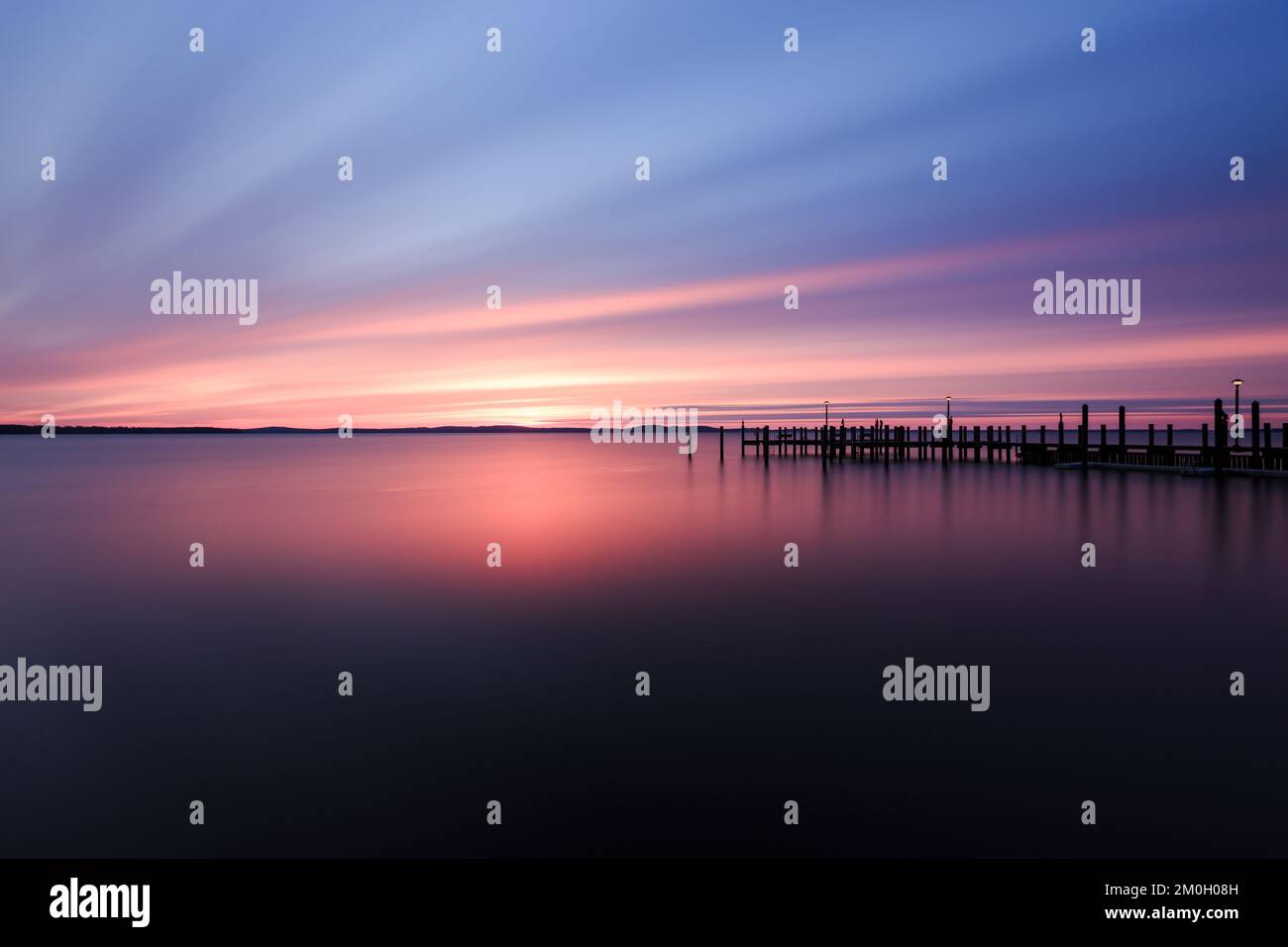 A long exposure of mesmerizing red glowing sky reflecting on the vast ...