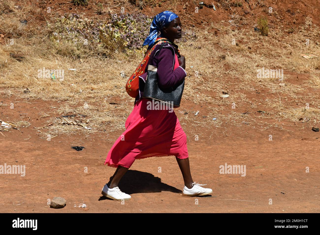 Young woman walking on the roadside, Kenya, Africa Stock Photo - Alamy