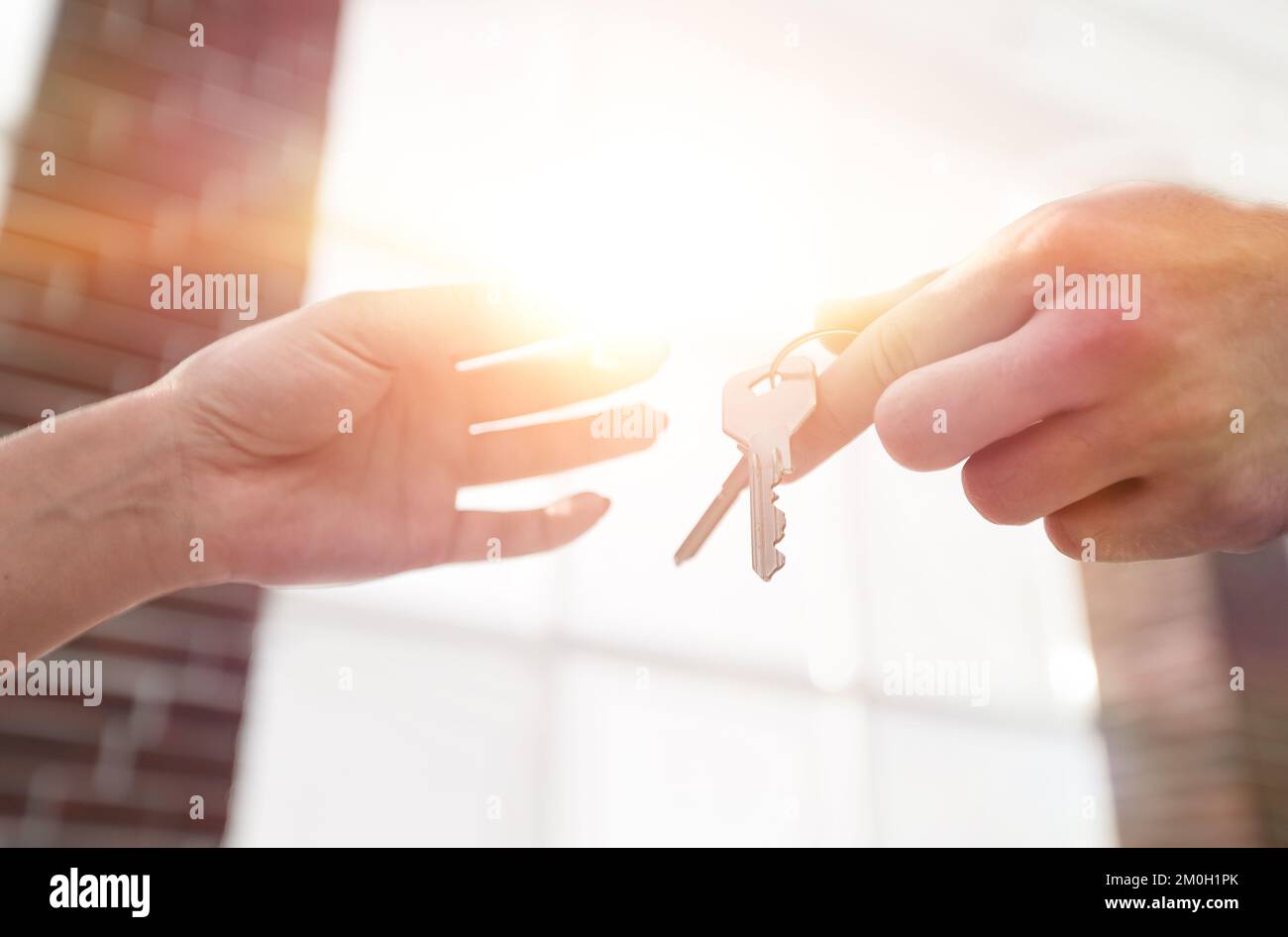 Cropped image of estate agent giving house keys to man in office Stock ...