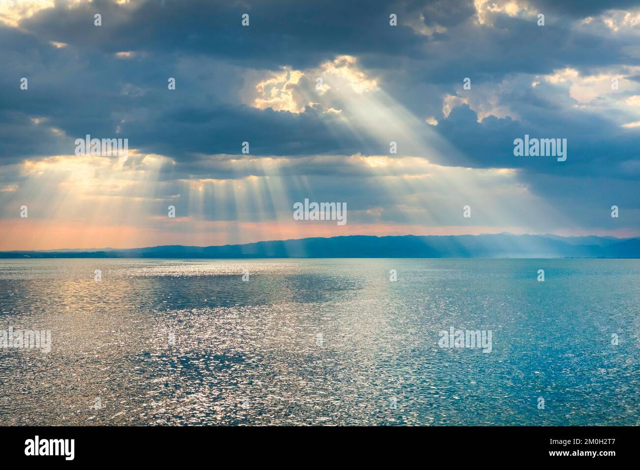 Tyndall effect over Lake Constance, sun rays break through cloudy sky ...