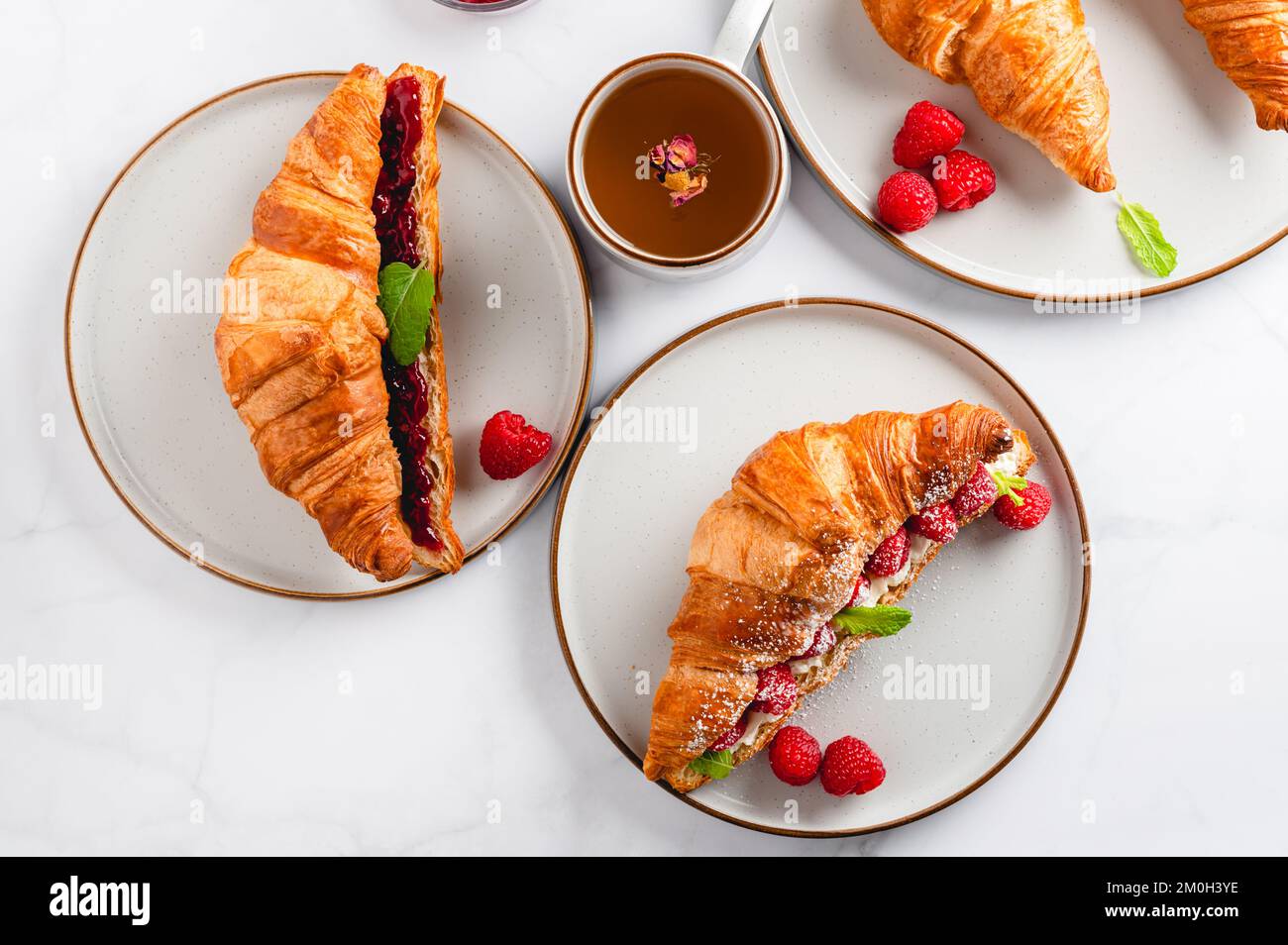 Croissant with fresh raspberries Stock Photo - Alamy