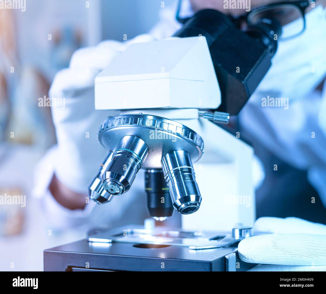 Biological scientist wear medical protective face mask looking at ...