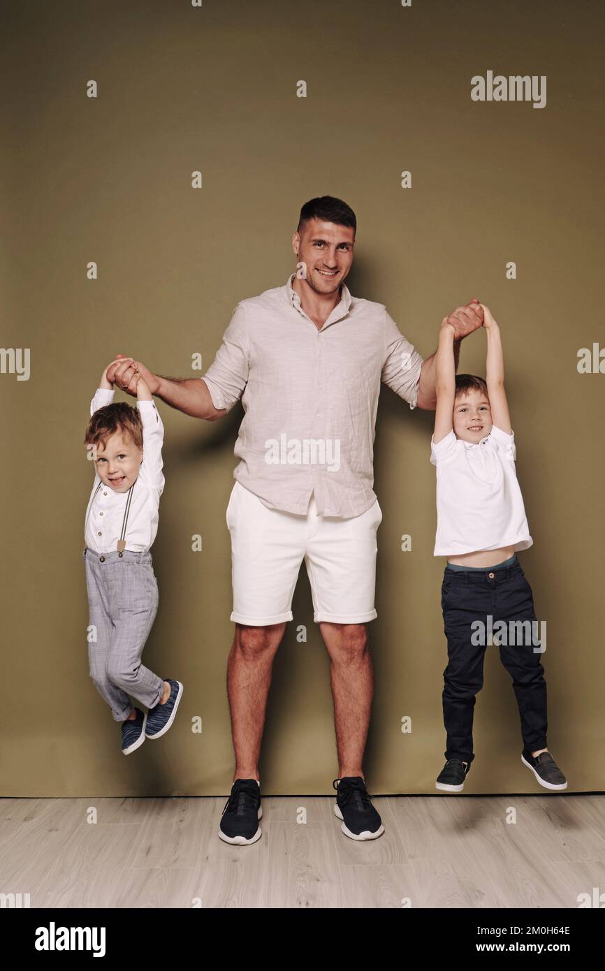Father and two sons, parenting Stock Photo - Alamy