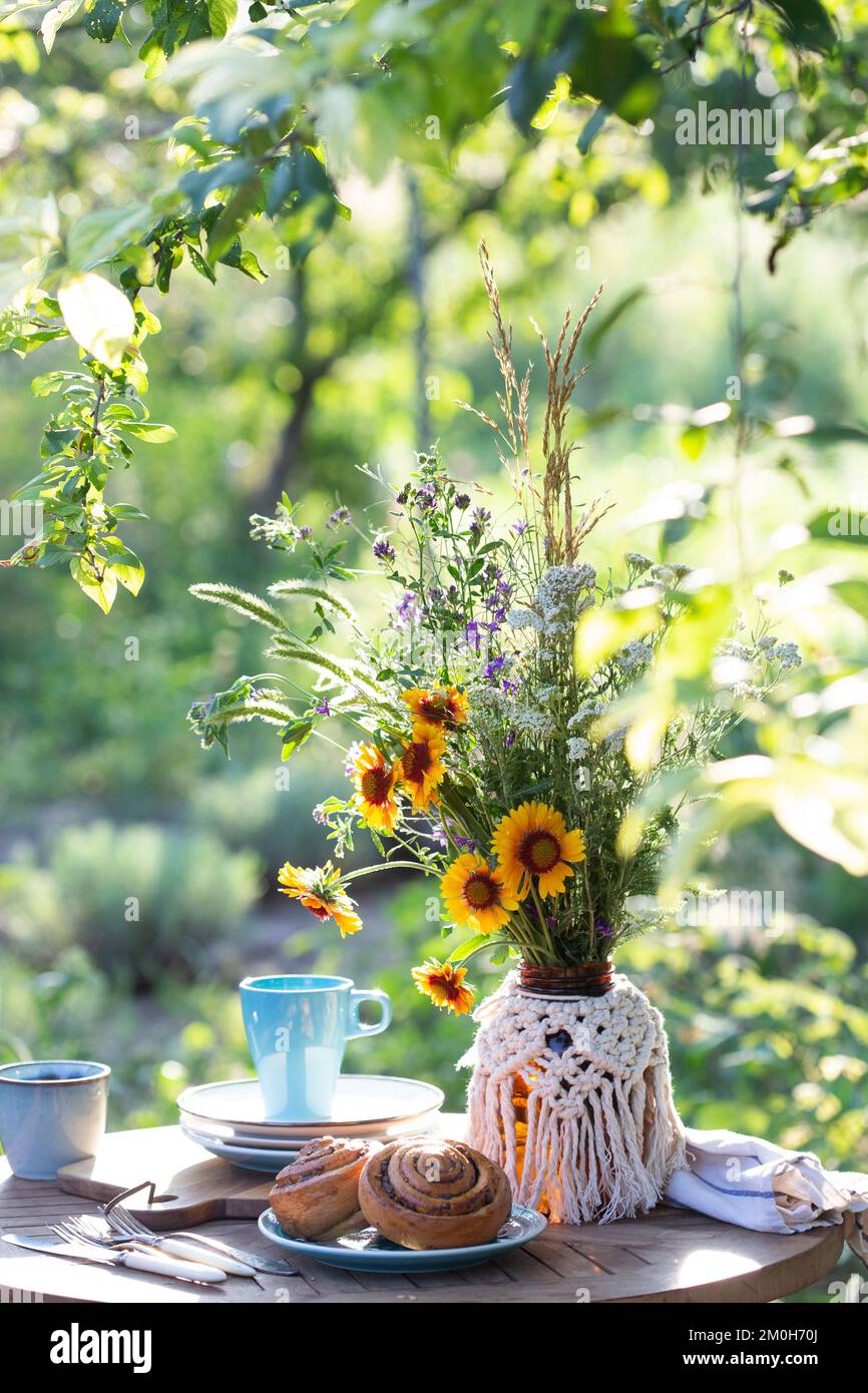 garden and tea party at the country style. still life - cinnamon rolls ...