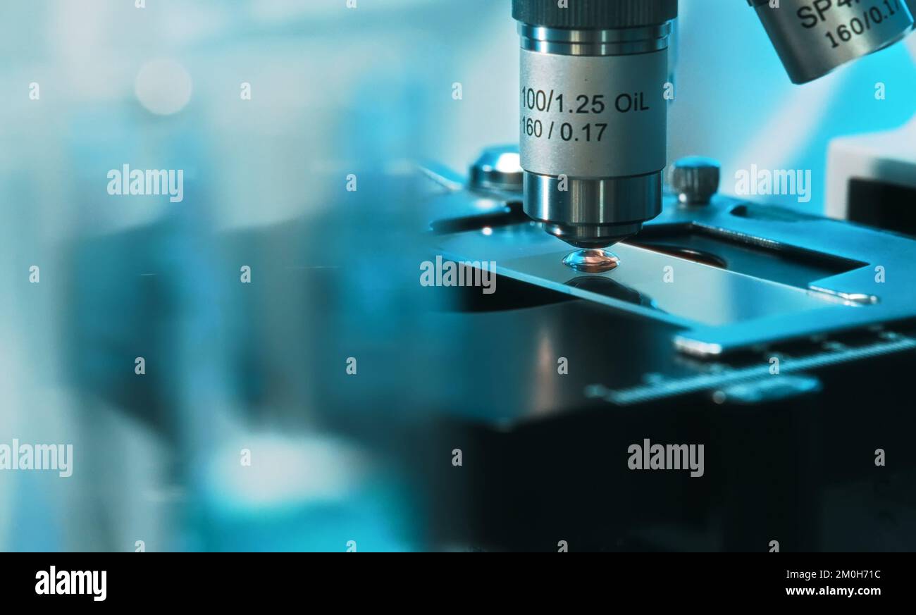 Working with microscope in science laboratory Stock Photo - Alamy