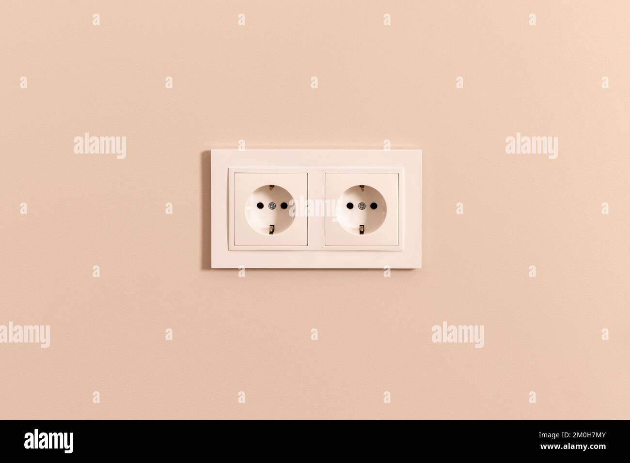 Group of white european electrical outlets on modern beige wall Stock ...