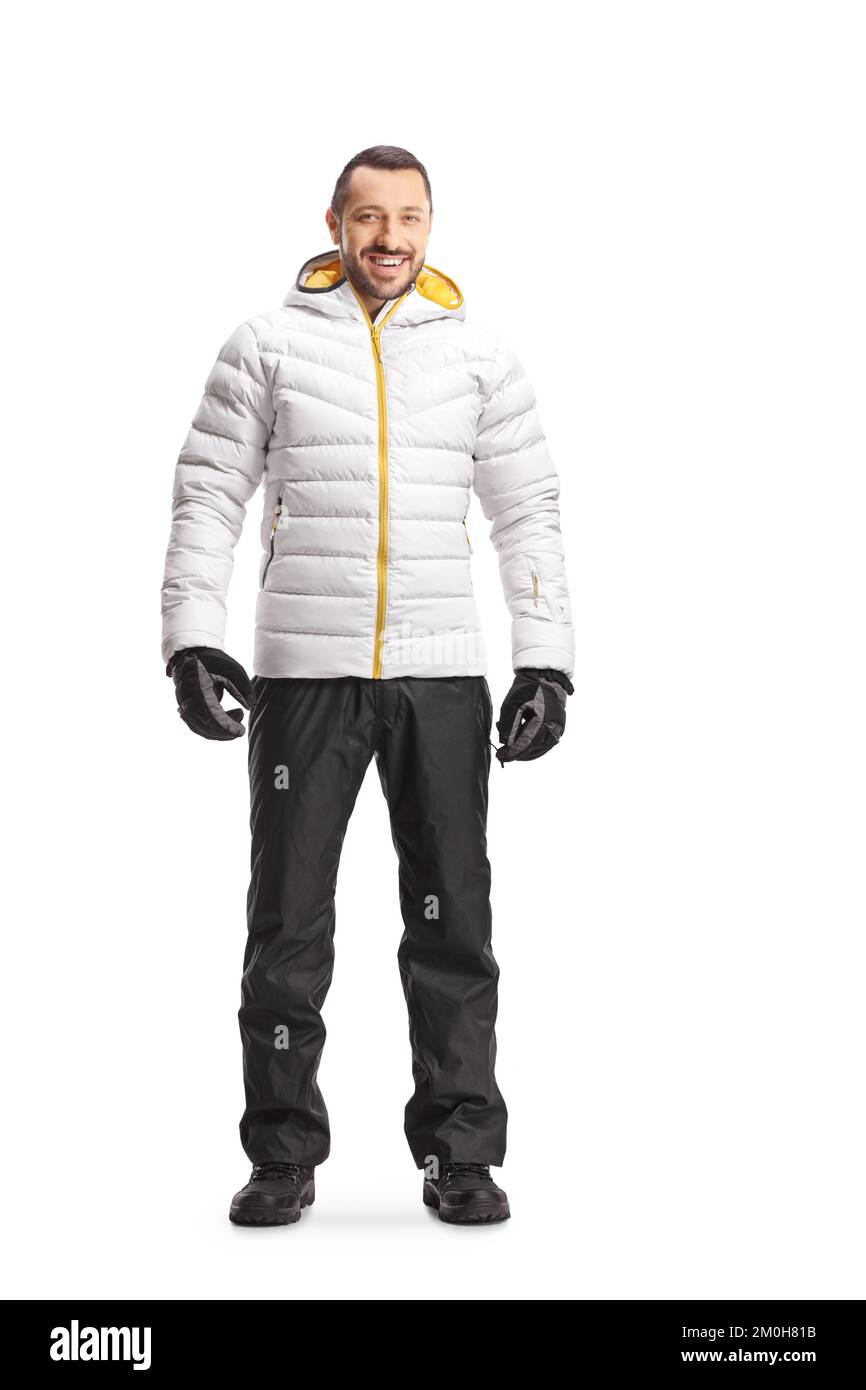 Full length portrait of a young man in a winter jacket and pants ...