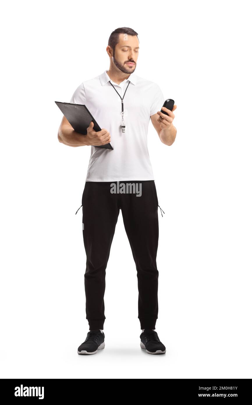 Sports coach with a whistle holding a clipboard and looking at a ...