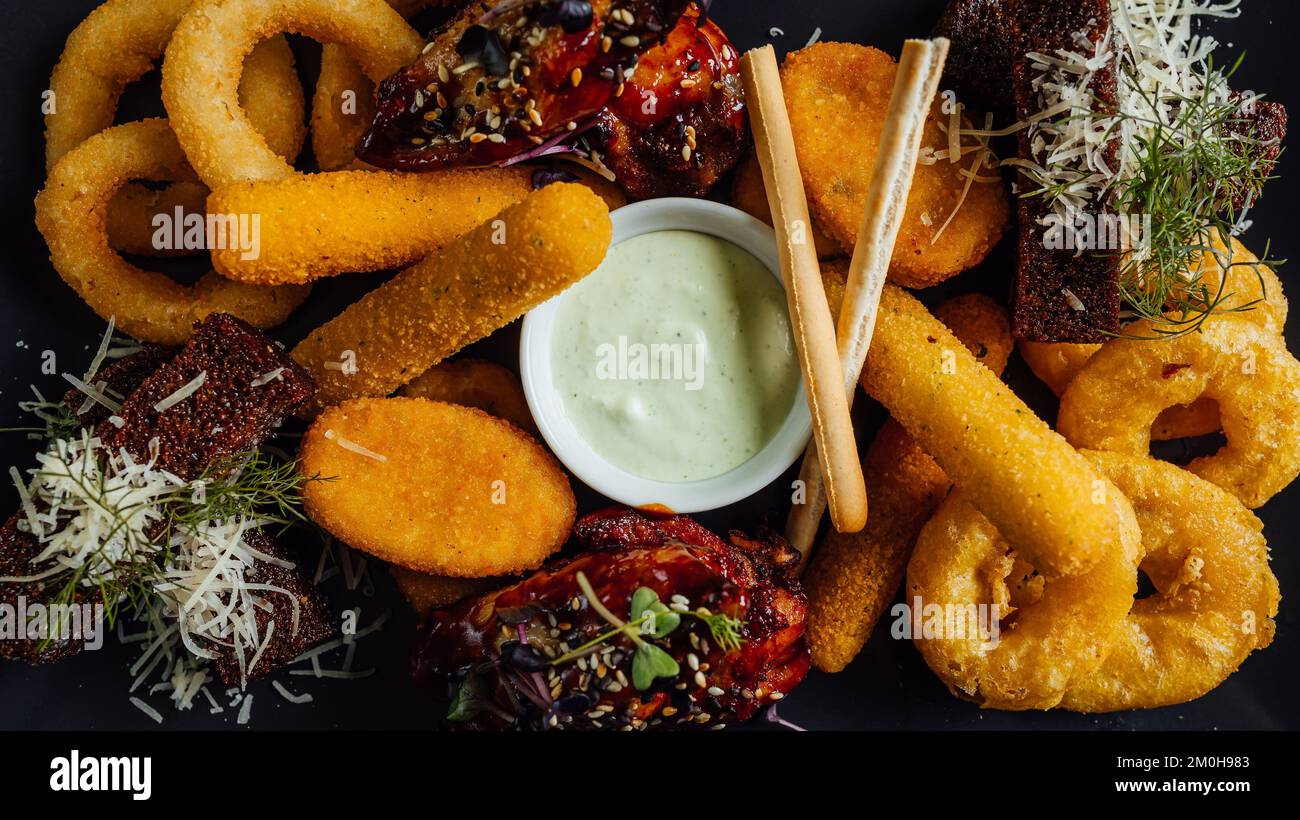 A top view of cheese nuggets and other snacks with sauce Stock Photo ...