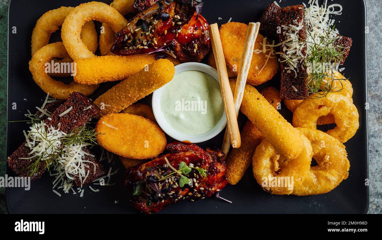 A top view of cheese nuggets and other snacks with sauce Stock Photo ...