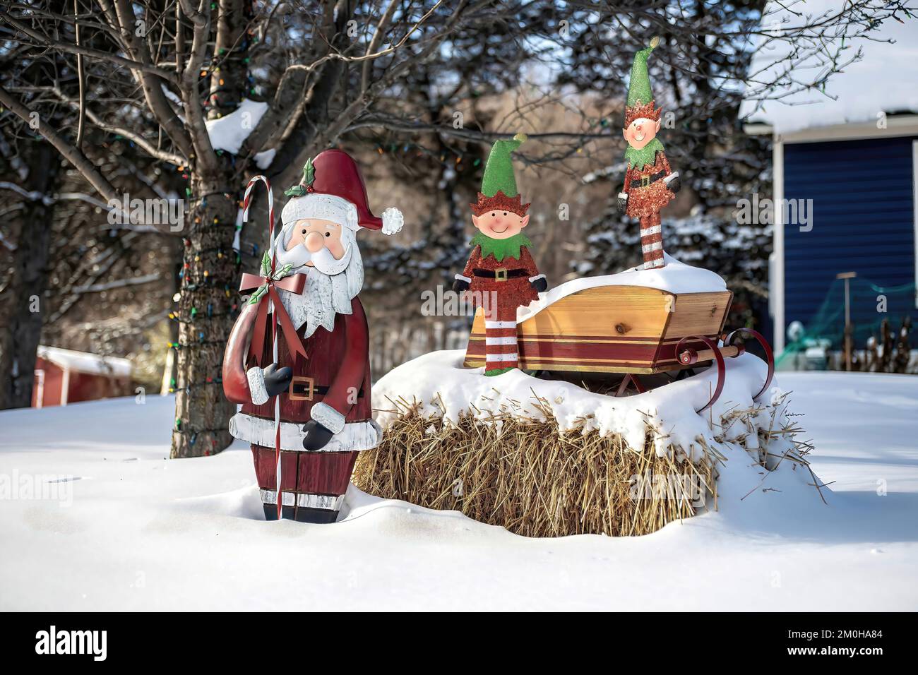 Christmas decoration with a santa and his sleigh with two elves atop a ...