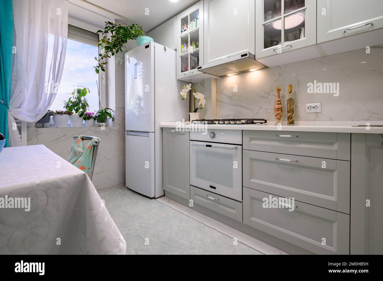 New light grey modern well designed kitchen interior Stock Photo - Alamy