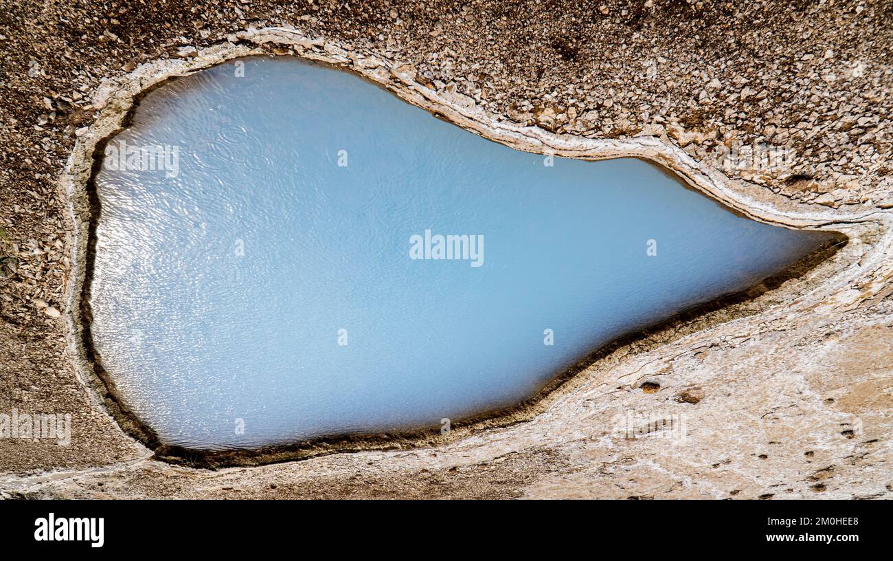 An aerial view of tiny pool in a geothermal area in Geysir, Iceland ...