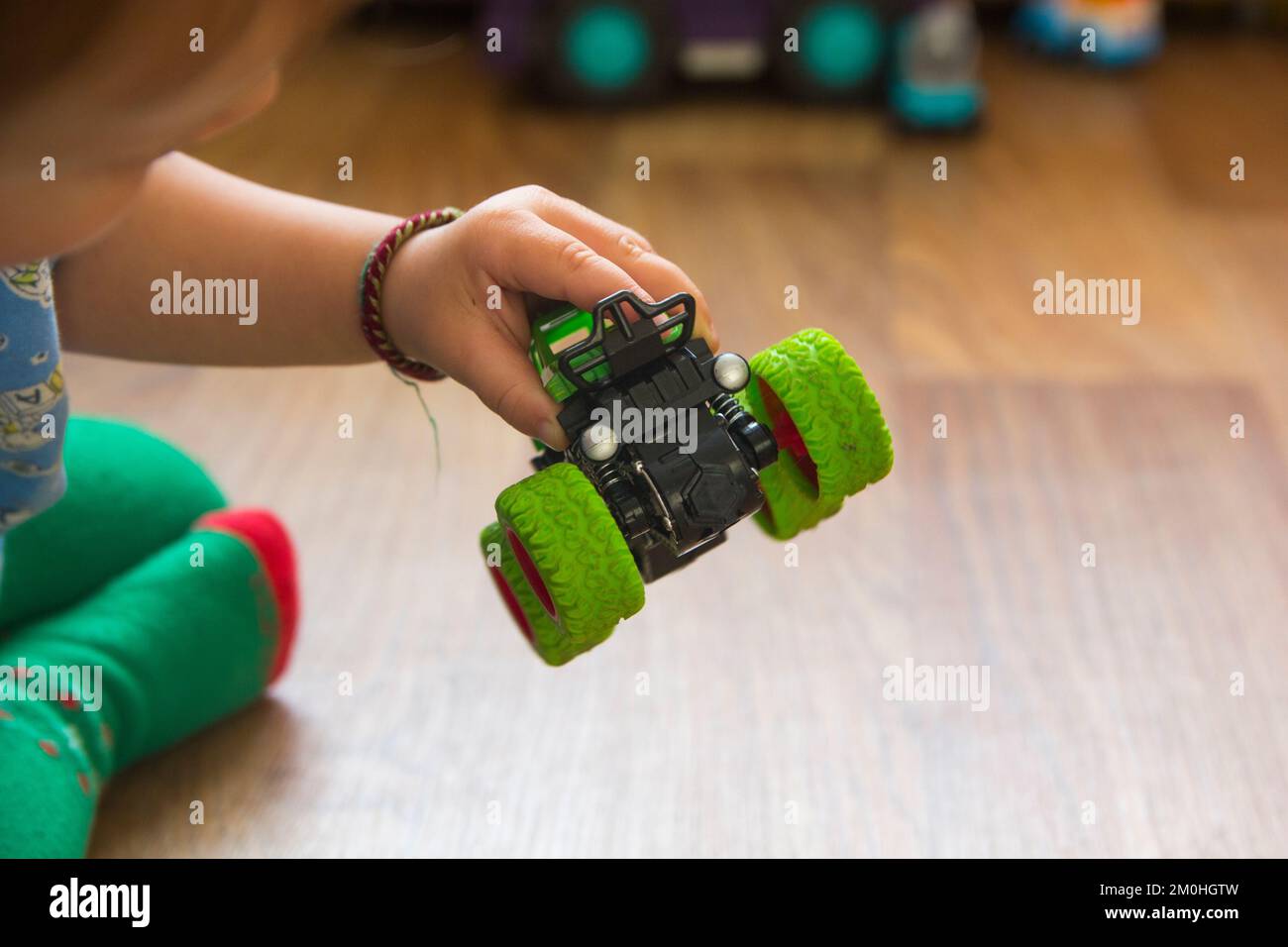Kid's hand holding a toy car close-up Stock Photo - Alamy