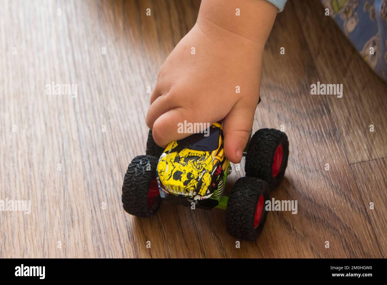 Kid's hand holding a toy car close-up Stock Photo - Alamy