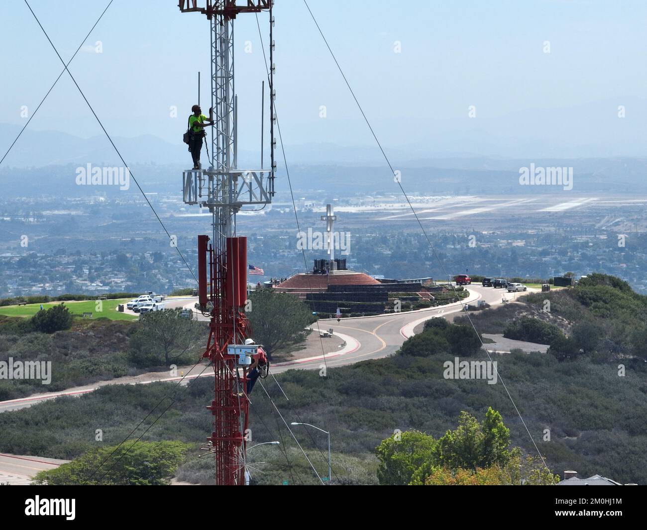 Engineer with safety equipment on high tower for working telecom ...