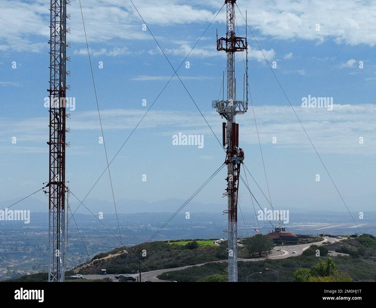 Engineer with safety equipment on high tower for working telecom ...