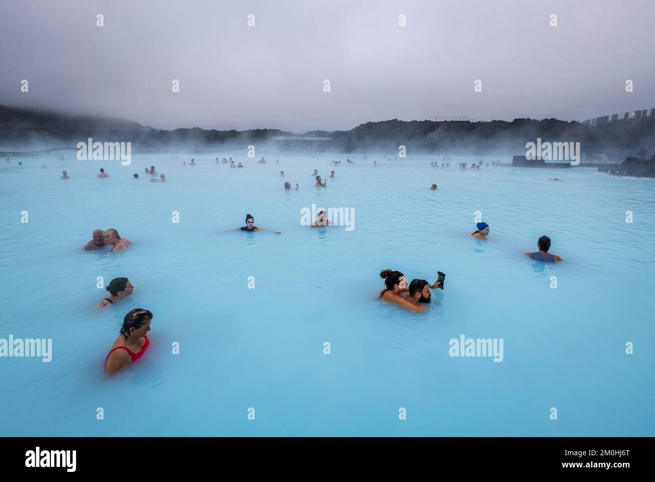 Iceland, Sudurnes region, Grindavik, Reykjanes peninsula, the Blue Lagoon, bathers basking in a ...