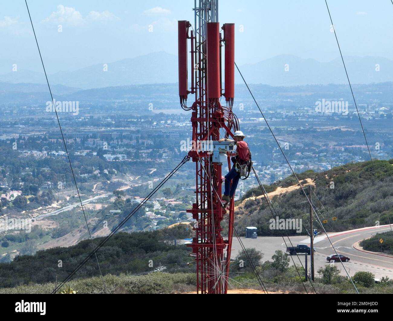 Engineer with safety equipment on high tower for working telecom ...