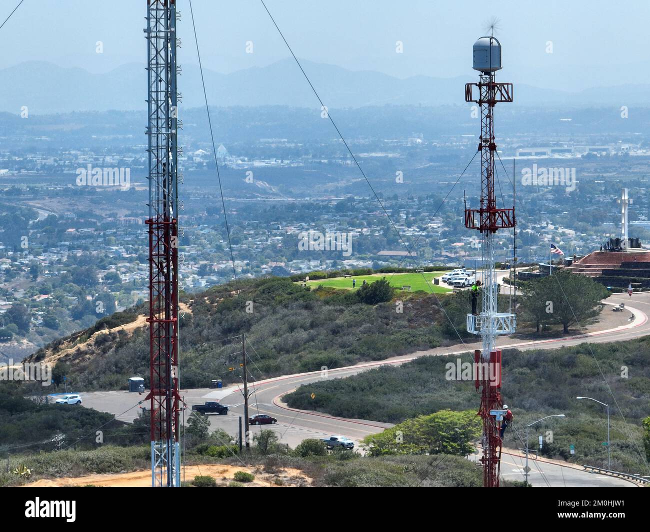 Engineer with safety equipment on high tower for working telecom ...