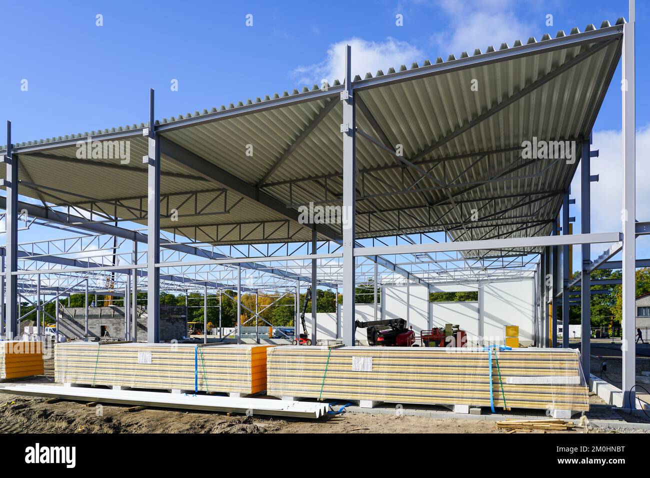 Steel framework with corrugated metal roof panels covering before ...