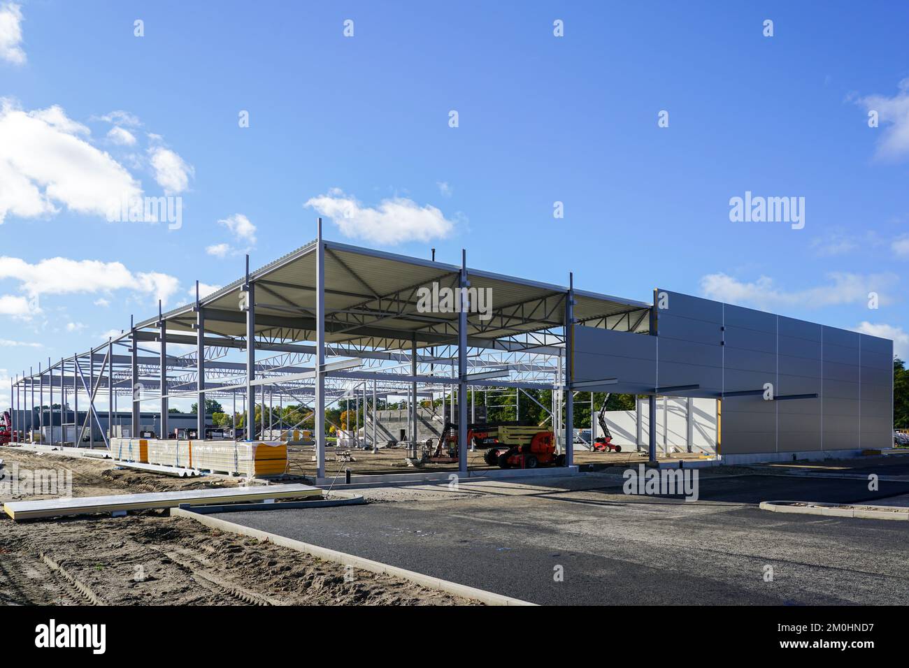 Unfinished steel framework with partially assembled sandwich panel wall ...