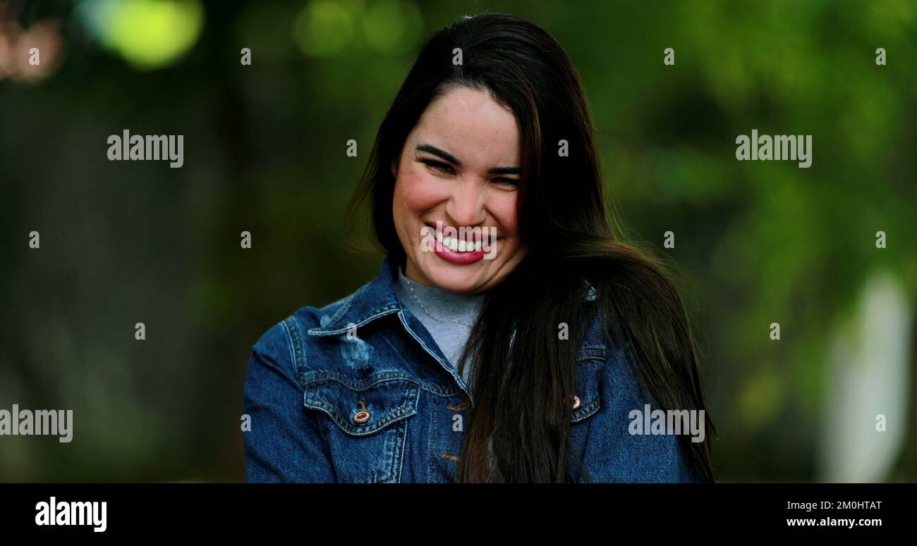 Happy millennial girl smiling and laughing outside Stock Photo - Alamy