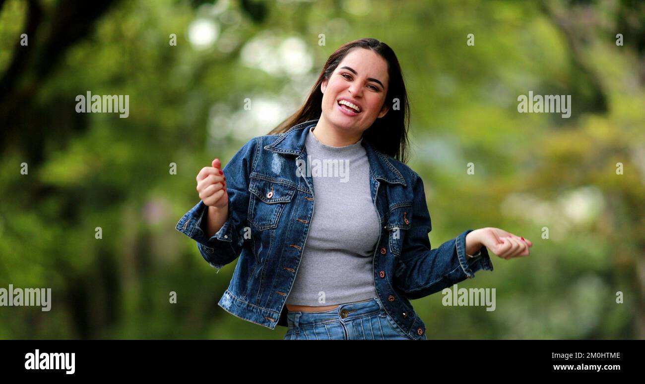 Fun excited happy young woman dancing with joy outside in nature Stock ...