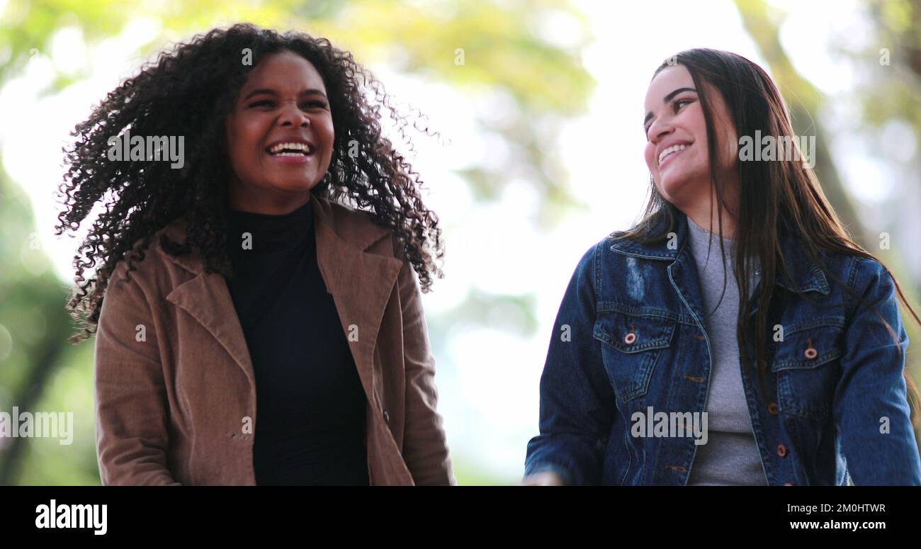 Diverse two friends celebrating life laughing and smiling Stock Photo ...