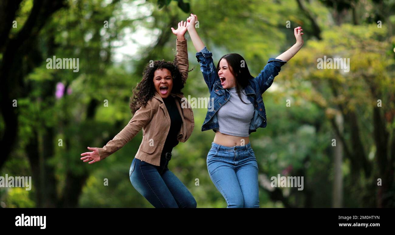Enthusiastic fun girls jumping in the air Stock Photo - Alamy
