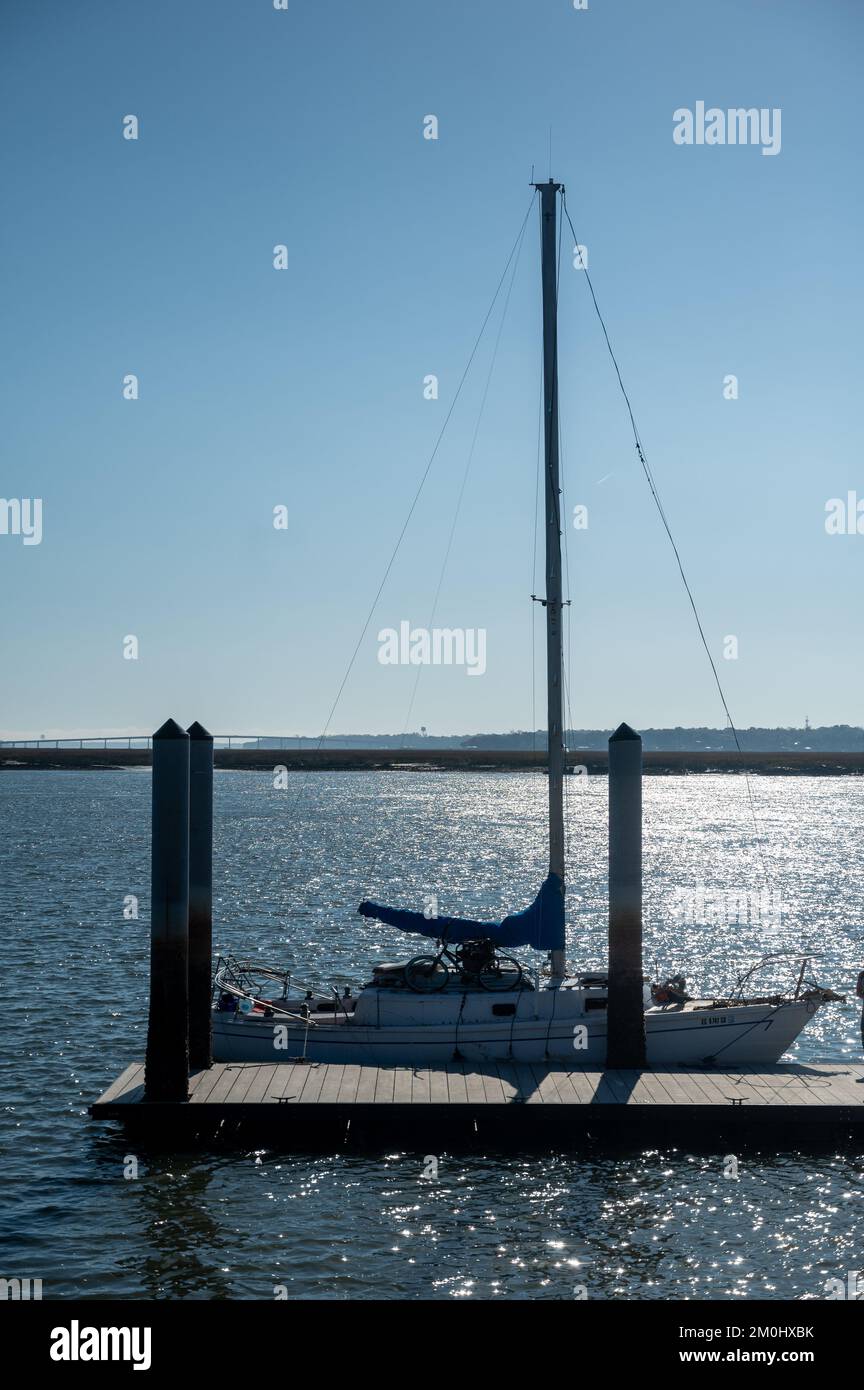 A vertical shot of a moored ship at the pier on a bright sunny day ...
