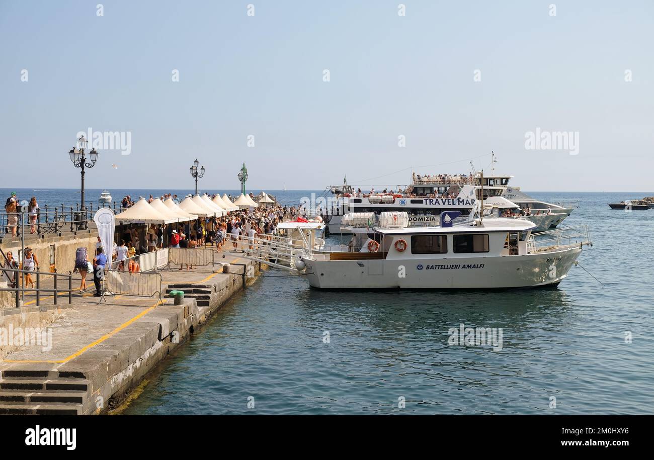 Day trip boats moored in the port of Amalfi Italy with passengers ...