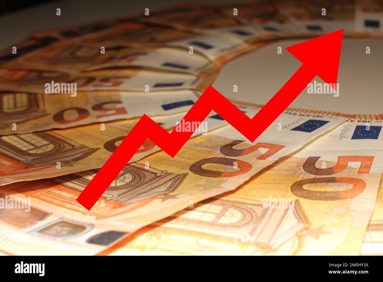 European banknotes with a red arrow going up Stock Photo - Alamy