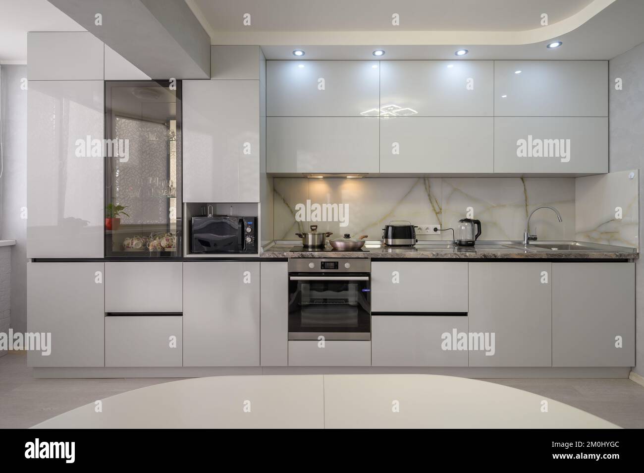 Interior of modern trendy white kitchen, front view Stock Photo - Alamy