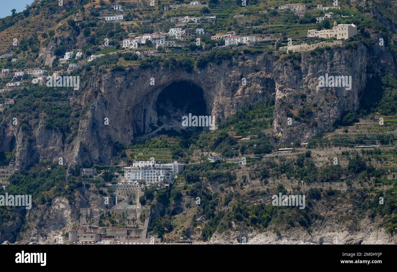 Large cave opening sits on the Amalfi coast amongst the limestone ...