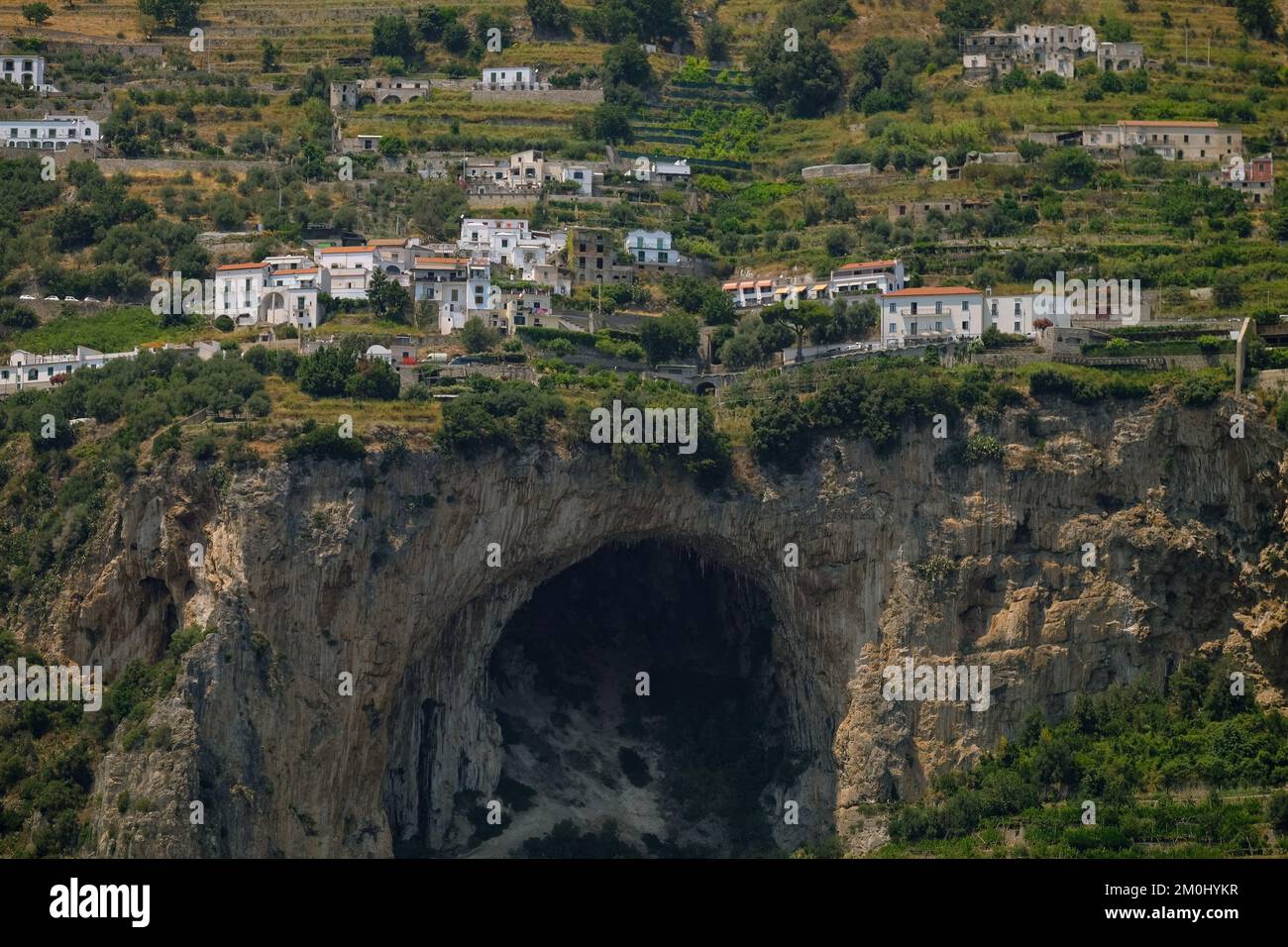 Large cave opening sits on the Amalfi coast amongst the limestone ...