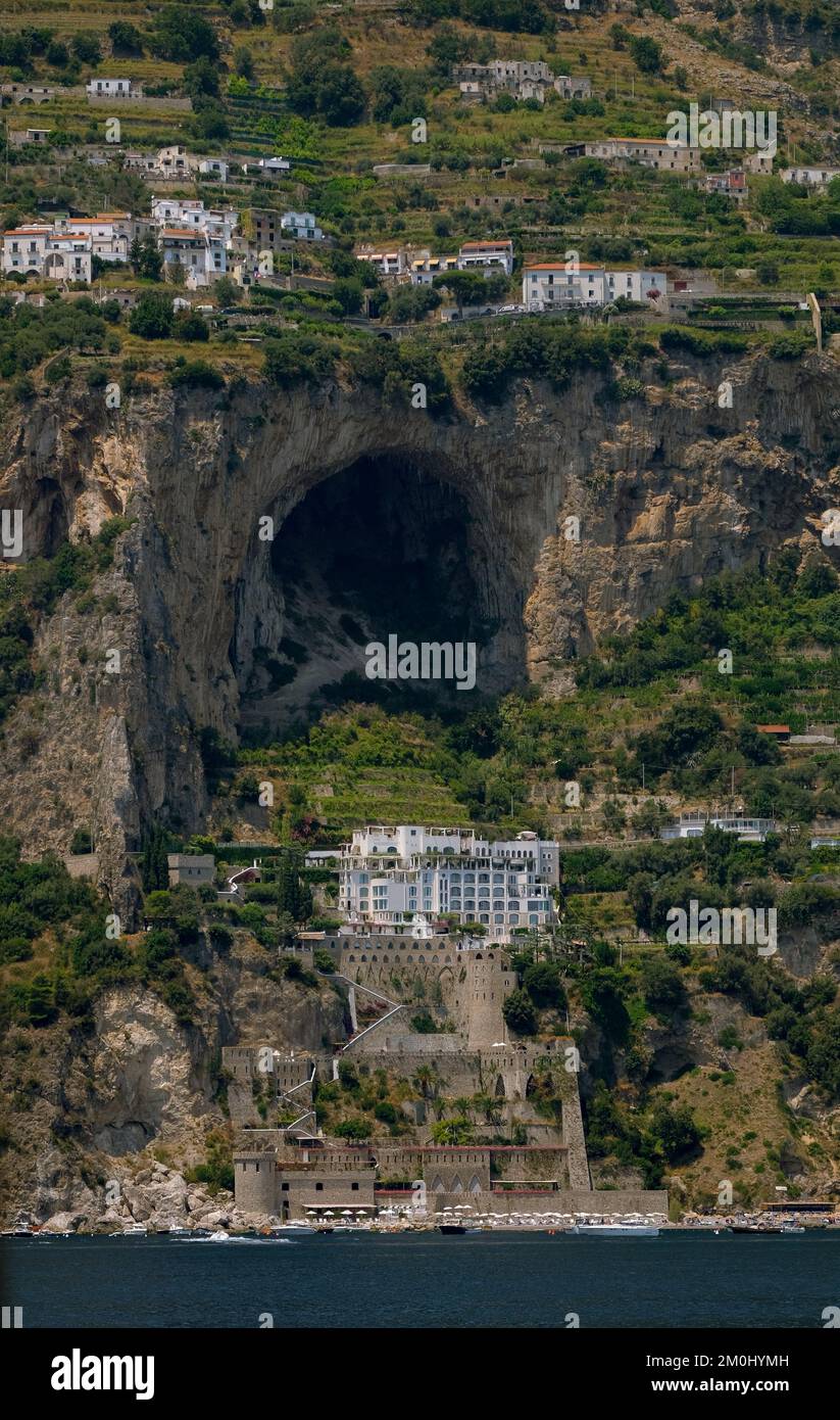 Large cave opening sits on the Amalfi coast amongst the limestone ...