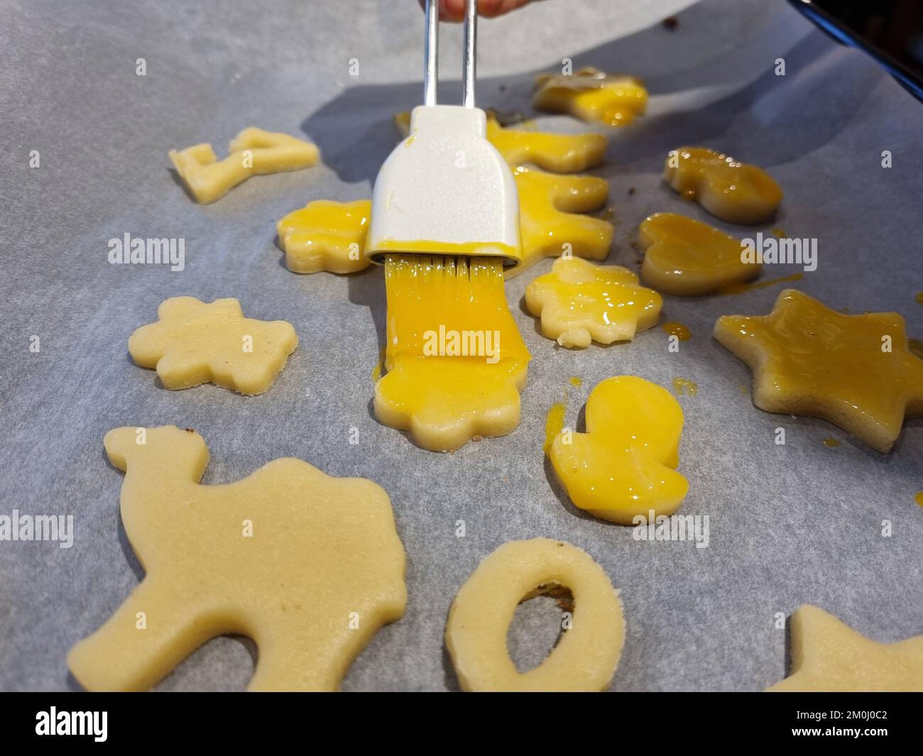 Sweet Cookies of different forms being painted in golden color Stock ...