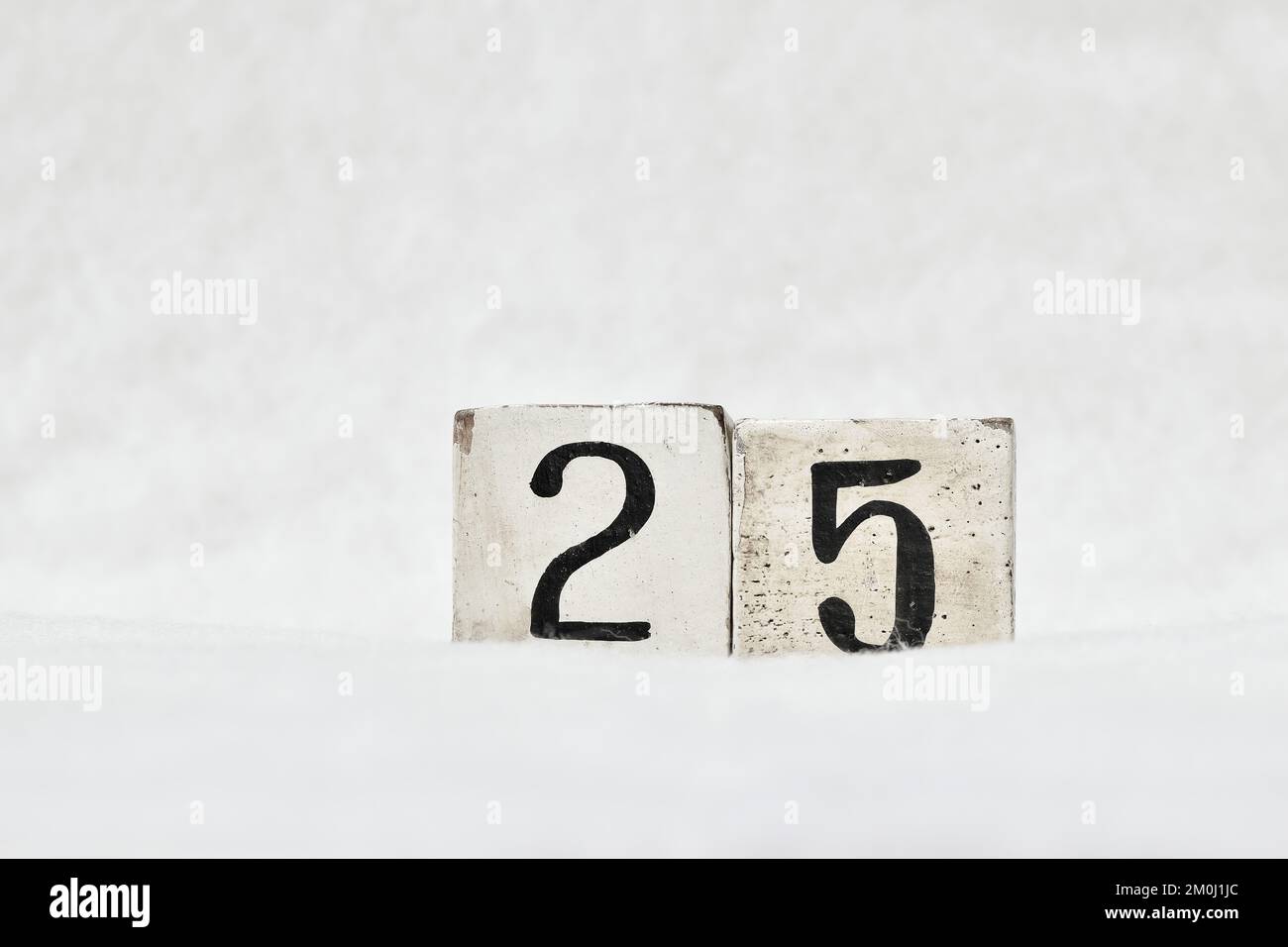 25 vintage wooden block calendar number on white snow background, copy ...