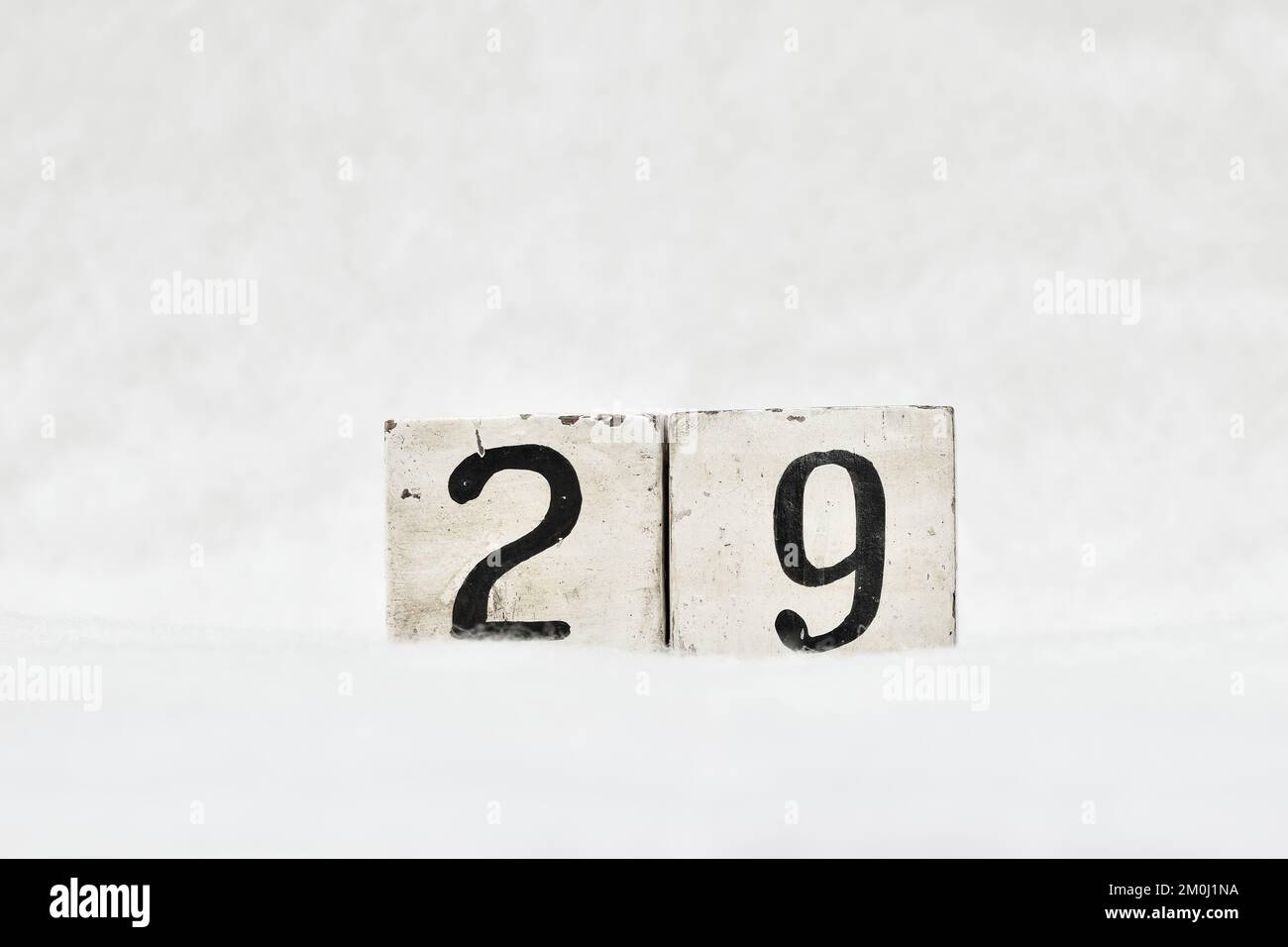 29 vintage wooden block calendar number on white snow background, copy ...