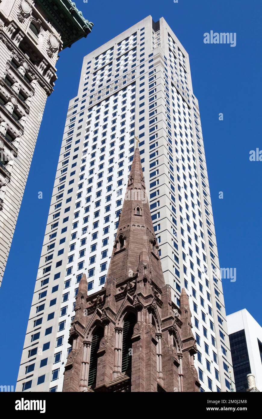 The view of a neo-gothic spire of historic church and a modern ...