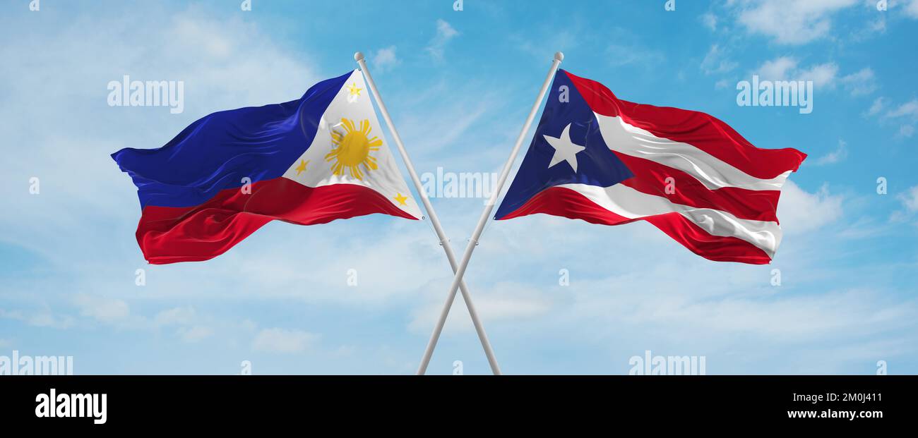 two crossed flags Puerto Rico and Philippines waving in wind at cloudy sky. Concept of ...